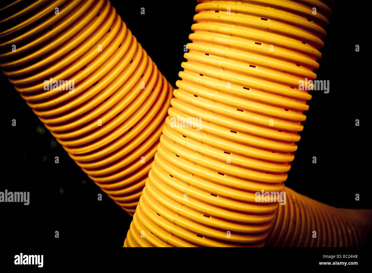 yellow plastic industrial construction tubes Stock Photo - Alamy
