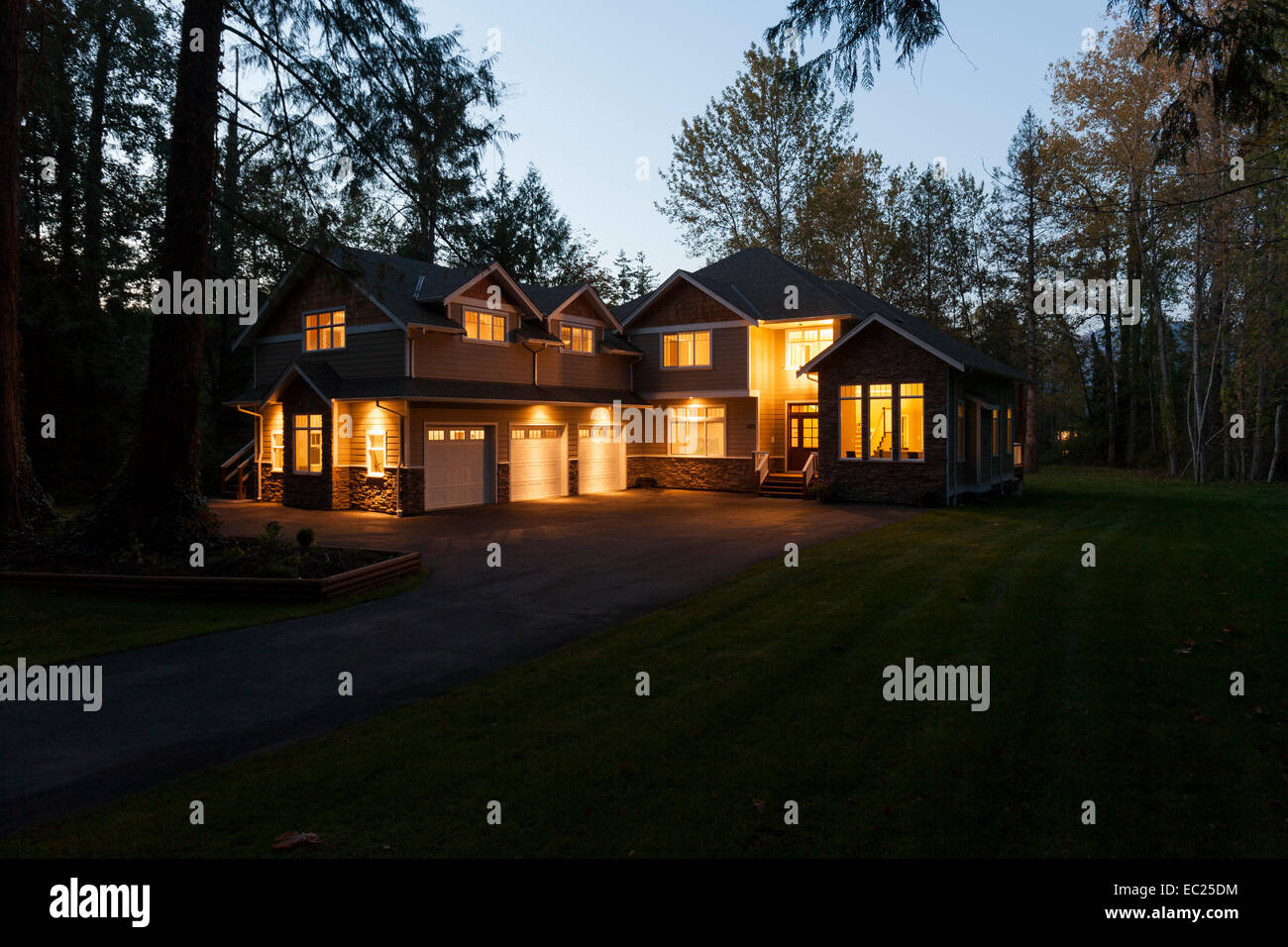 A home light up at dusk Stock Photo - Alamy