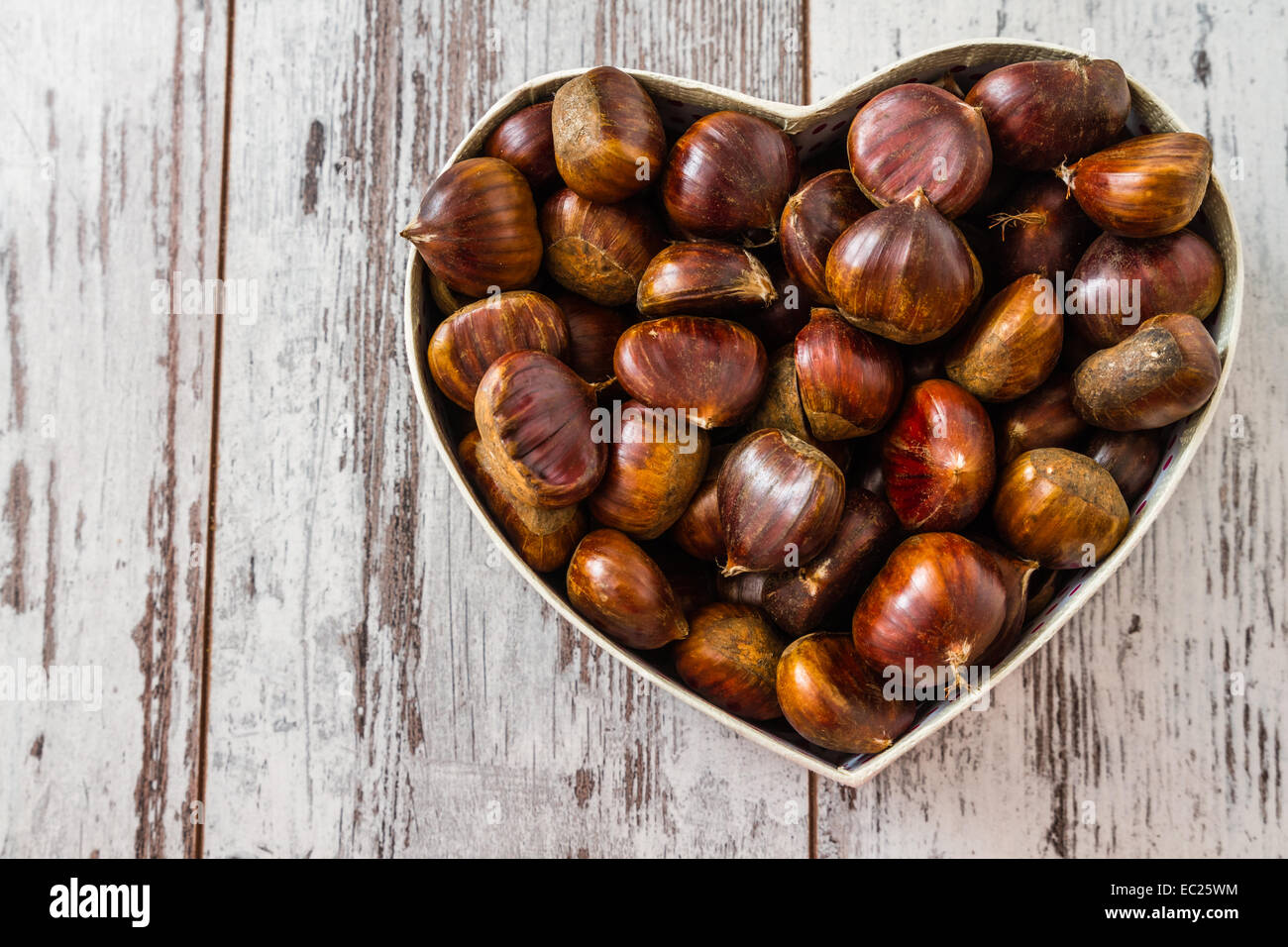 Fresh chestnuts in a heart shaped box on wooden white background Stock ...