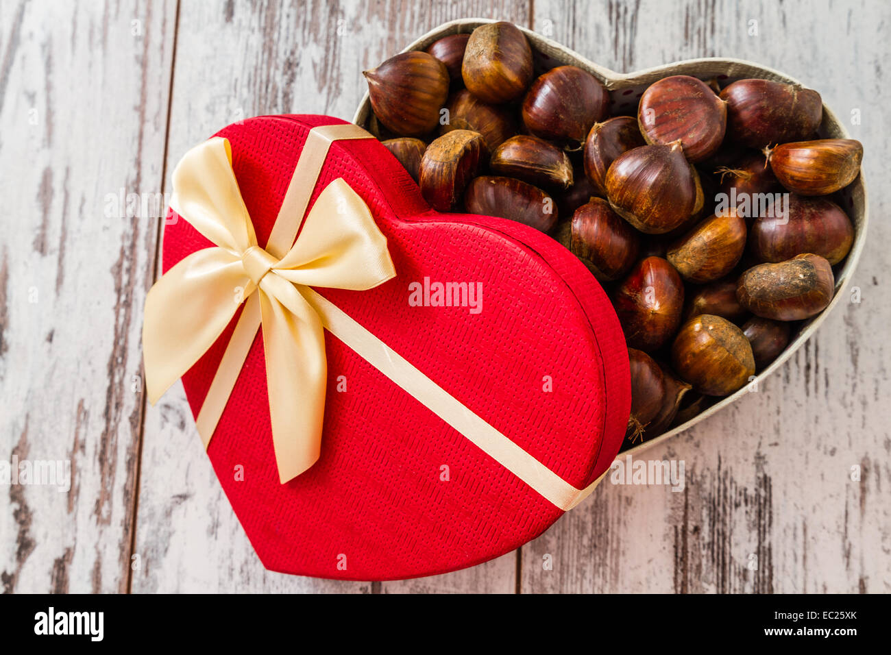 Fresh chestnuts in a heart shaped box on wooden white background Stock ...