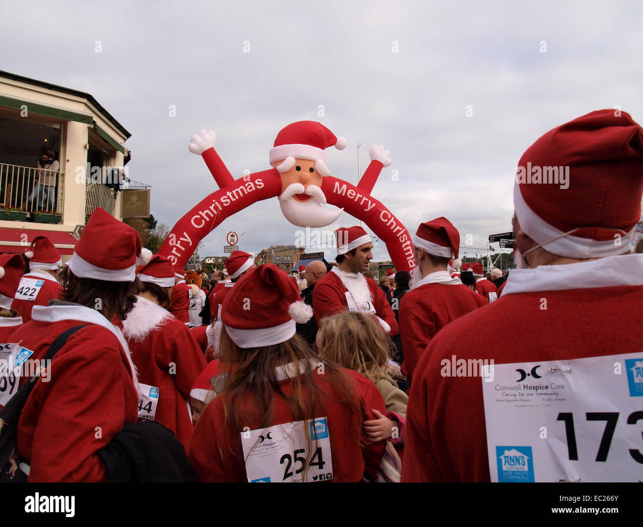 People in Santa suits awaiting the start of the Charity Santa run at ...