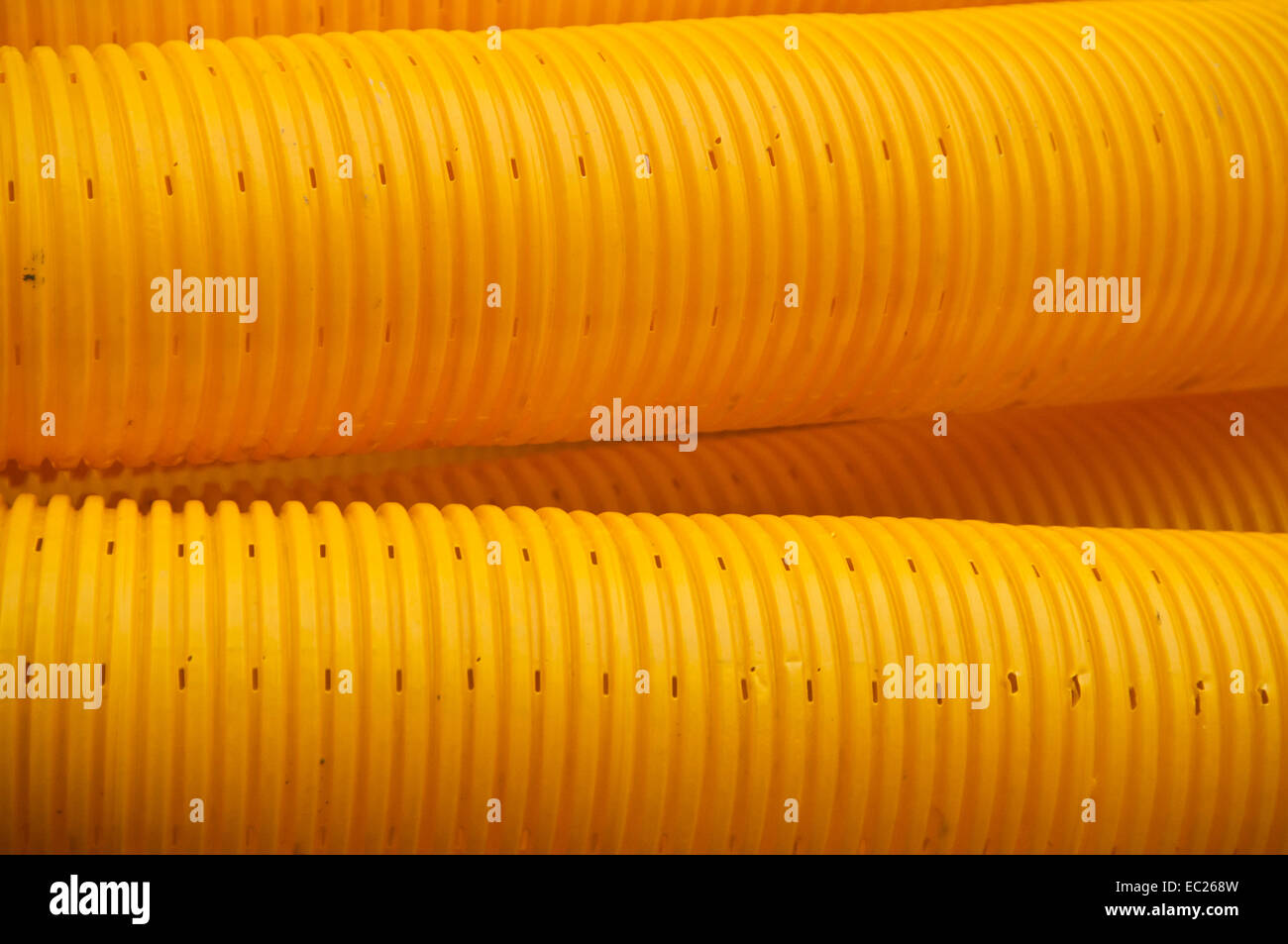 yellow plastic industrial construction tubes Stock Photo - Alamy