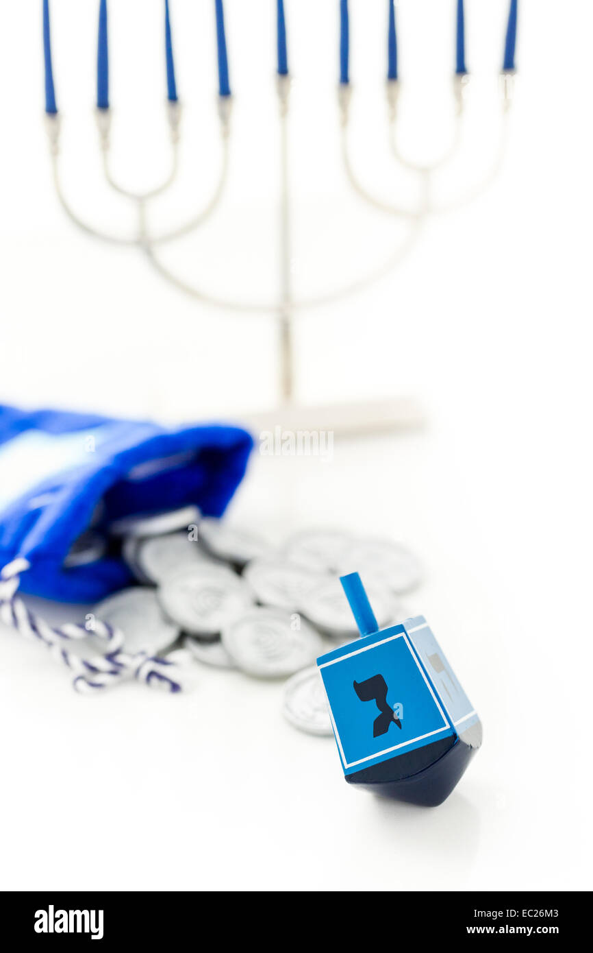 Blue dreidel with silver tokens on a white background Stock Photo - Alamy
