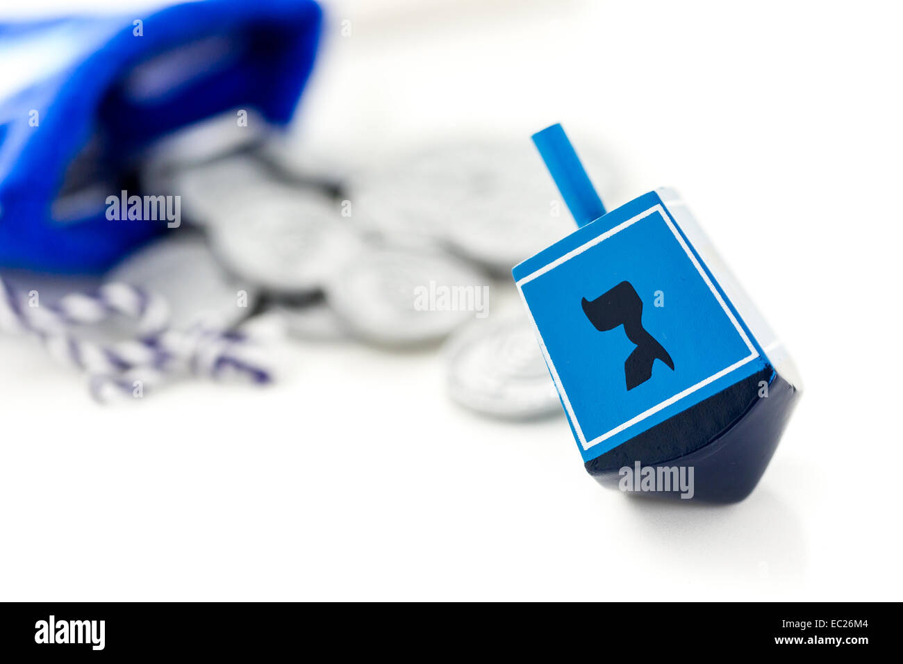 Blue dreidel with silver tokens on a white background Stock Photo - Alamy
