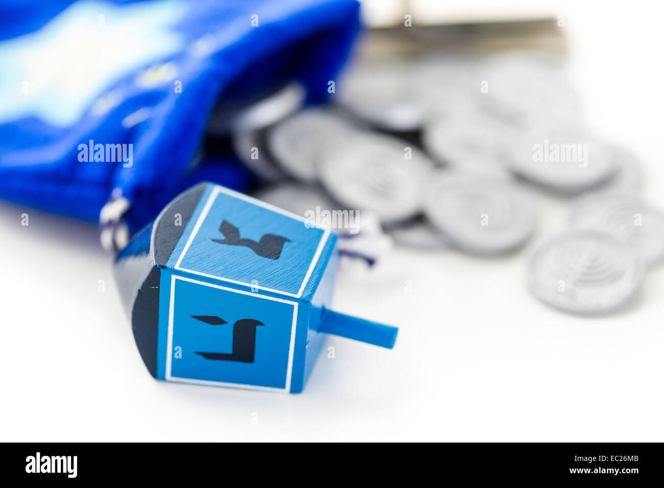 Blue dreidel with silver tokens on a white background Stock Photo - Alamy