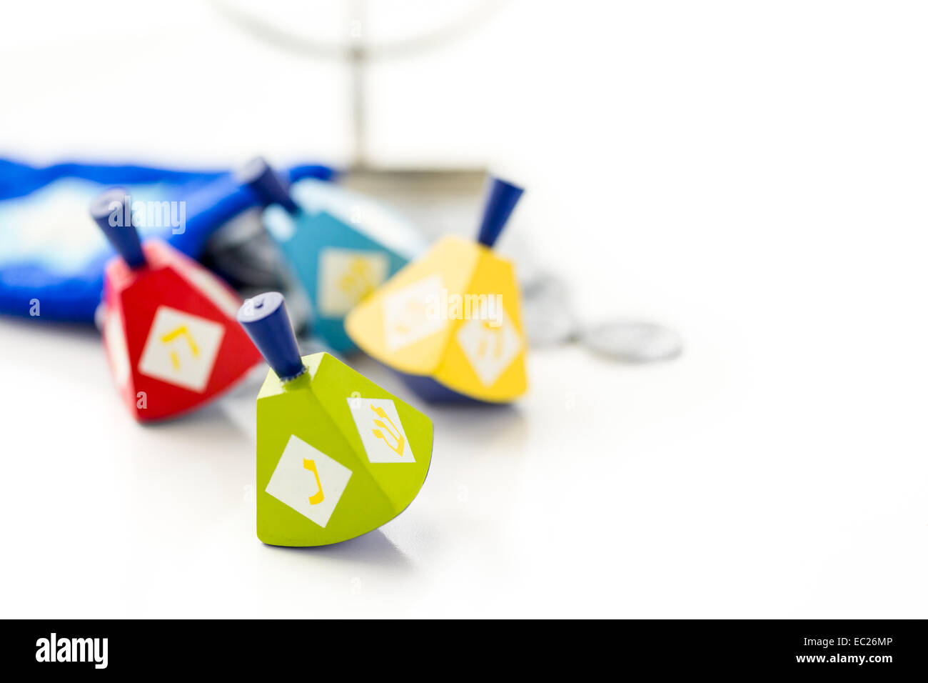 Colorful dreidels with silver tokens on a white background Stock Photo ...