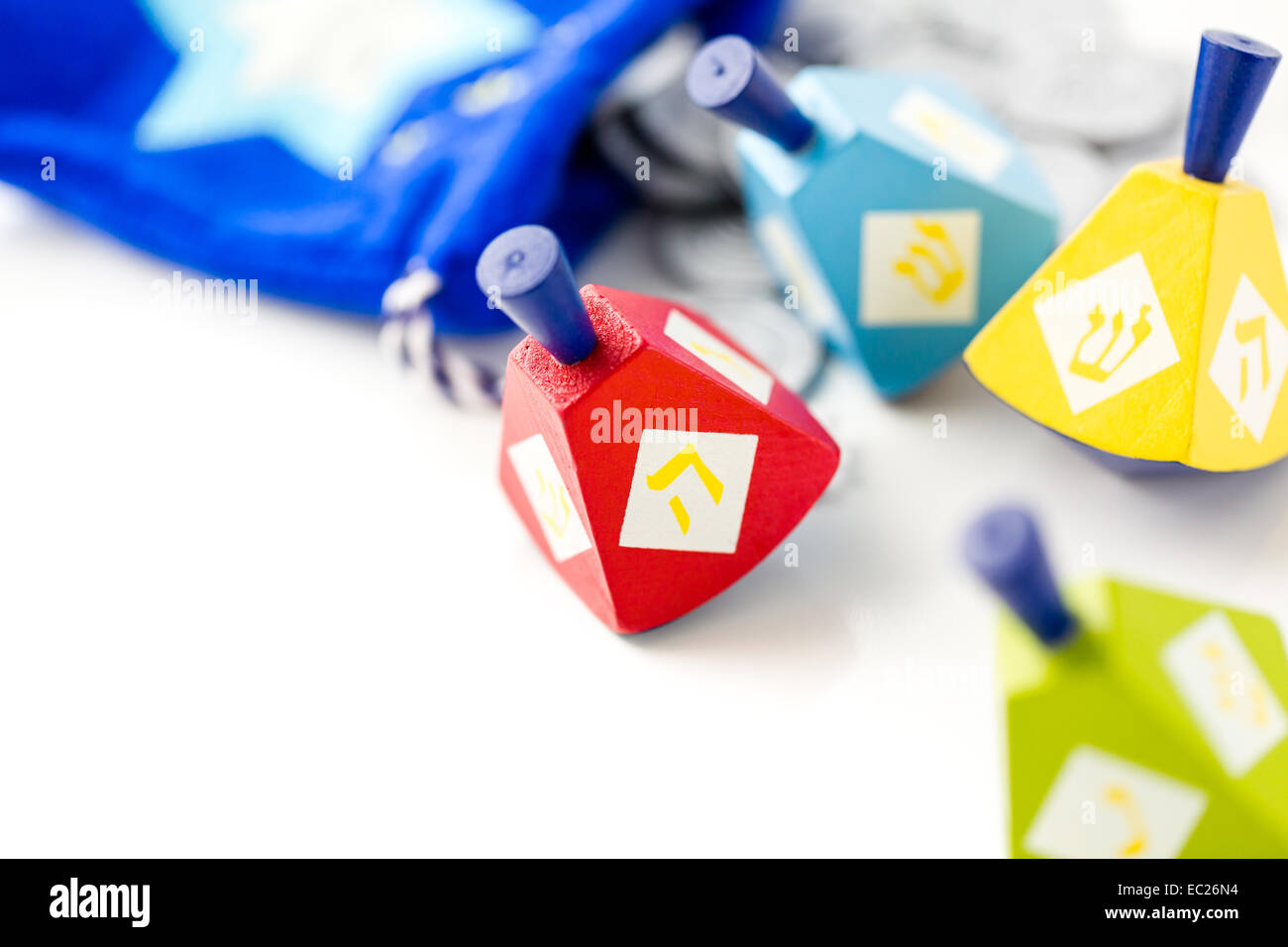 Colorful dreidels with silver tokens on a white background Stock Photo ...