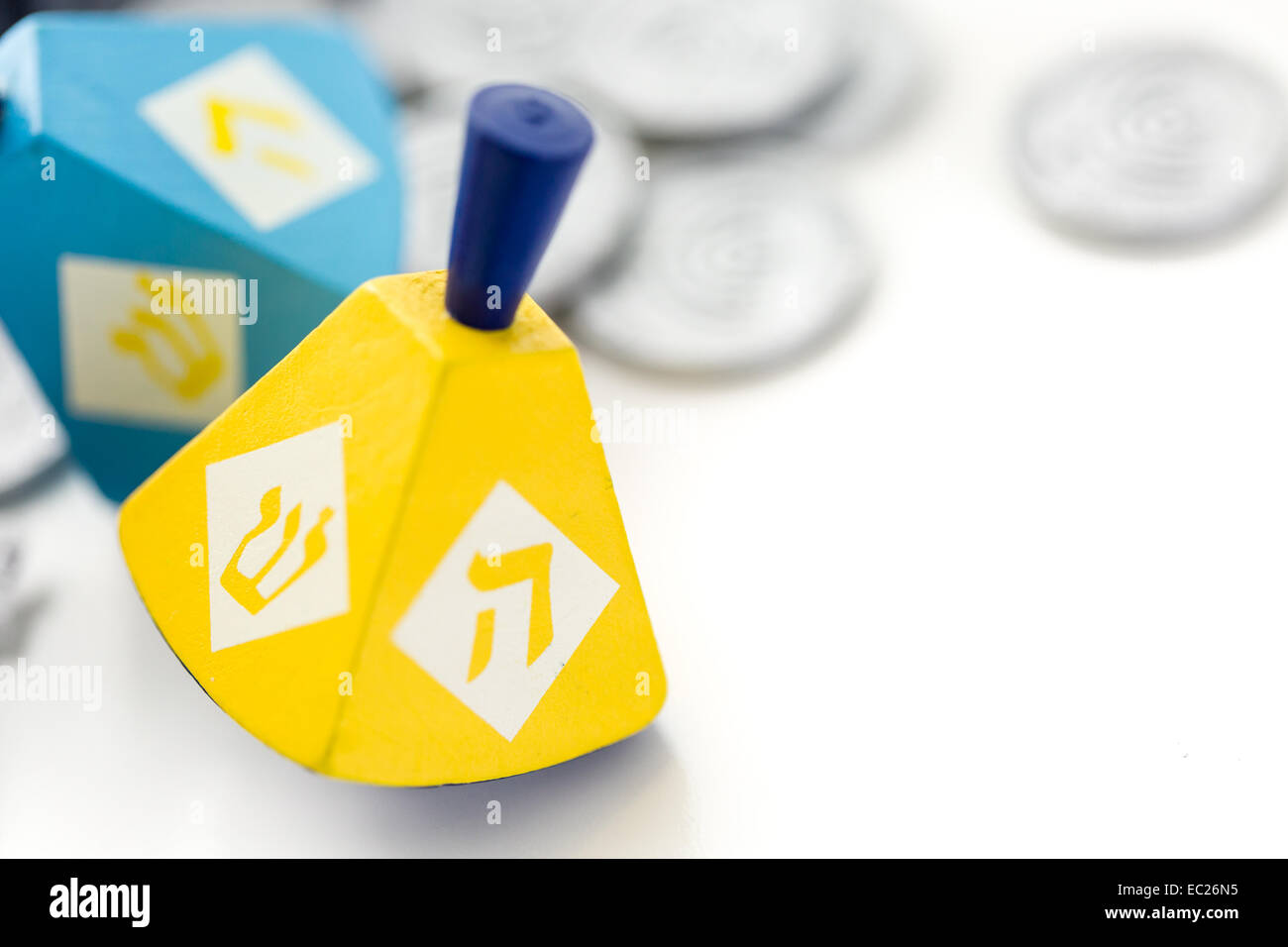 Colorful dreidels with silver tokens on a white background Stock Photo ...