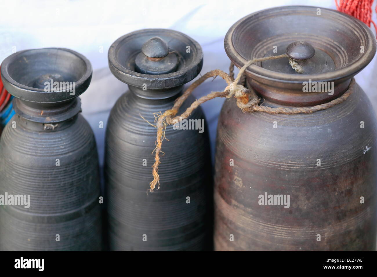 Cylindrical hand crafted pottery big vessels containing some liquids ...