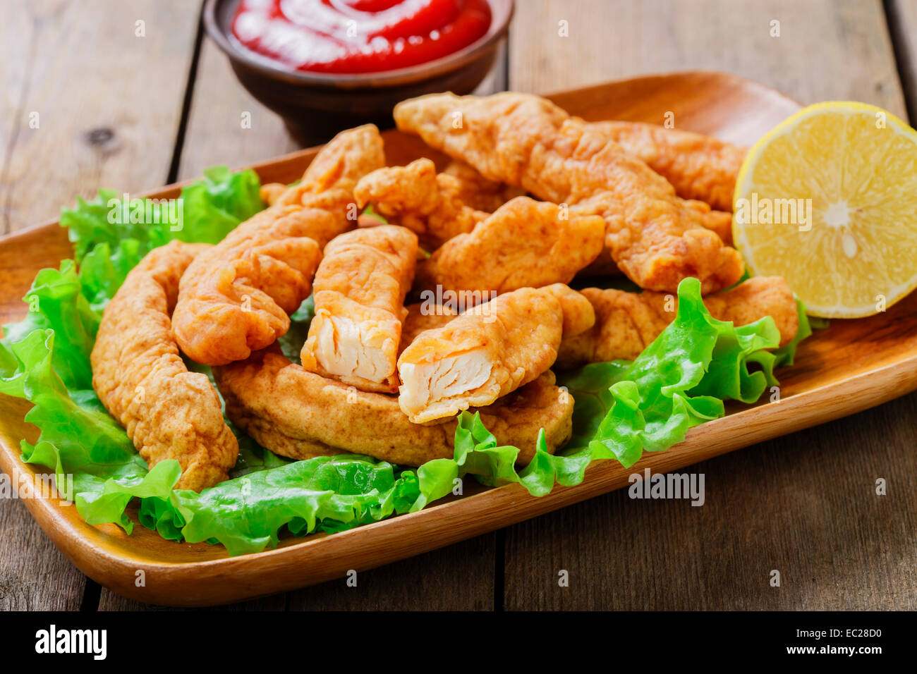 sticks breaded chicken with lemon Stock Photo - Alamy