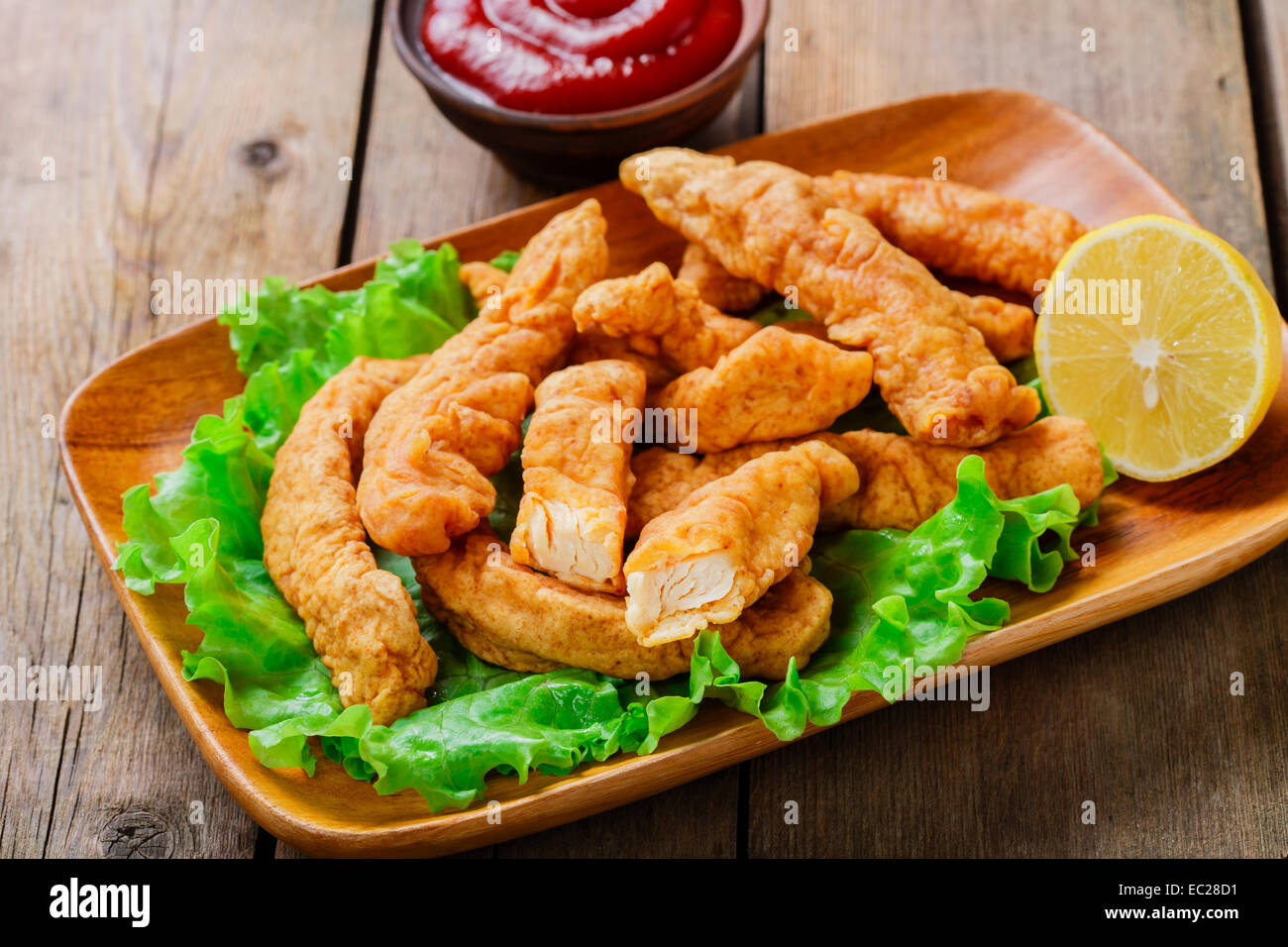 sticks breaded chicken with lemon Stock Photo - Alamy