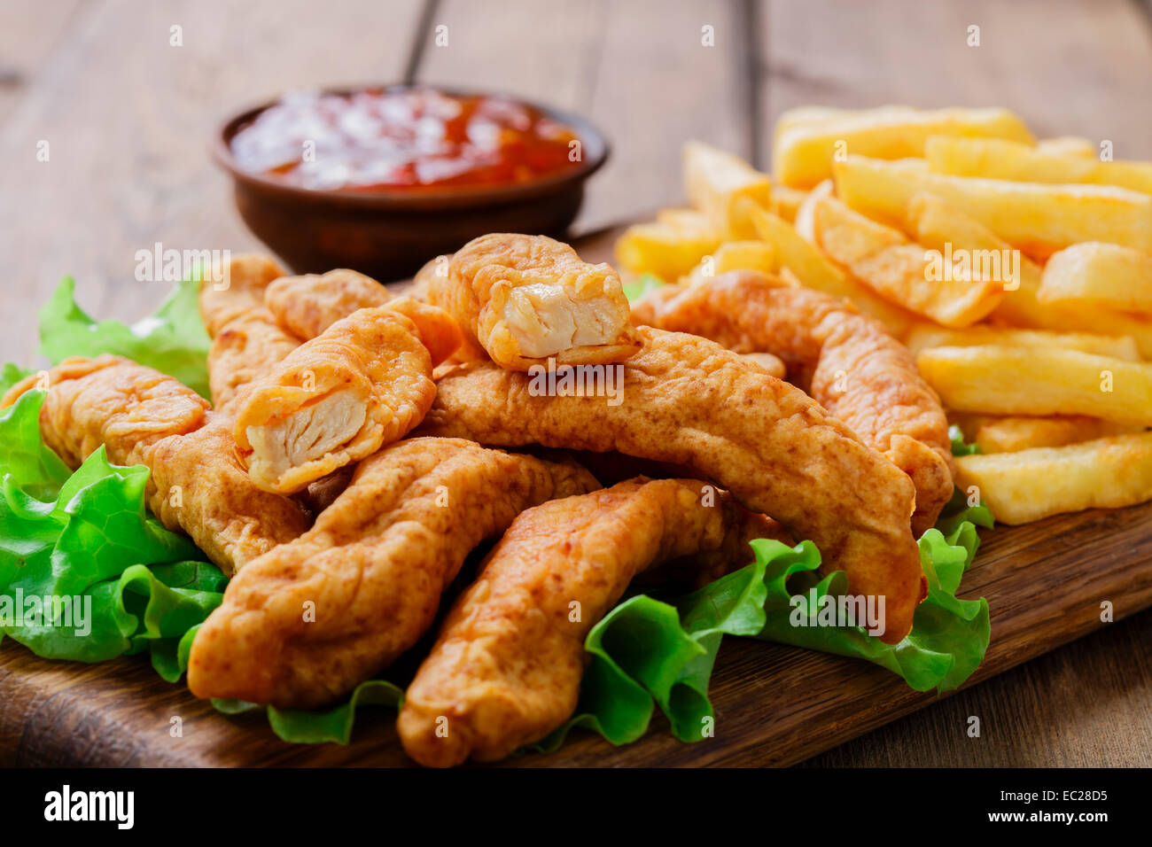 sticks breaded chicken with potatoes Stock Photo - Alamy