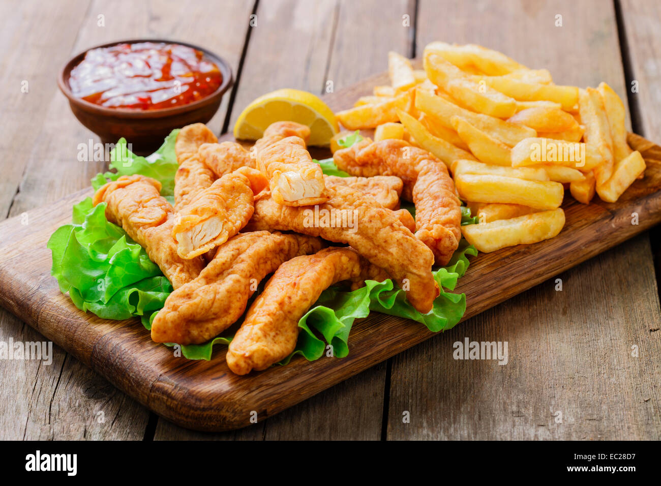sticks breaded chicken with potatoes Stock Photo - Alamy