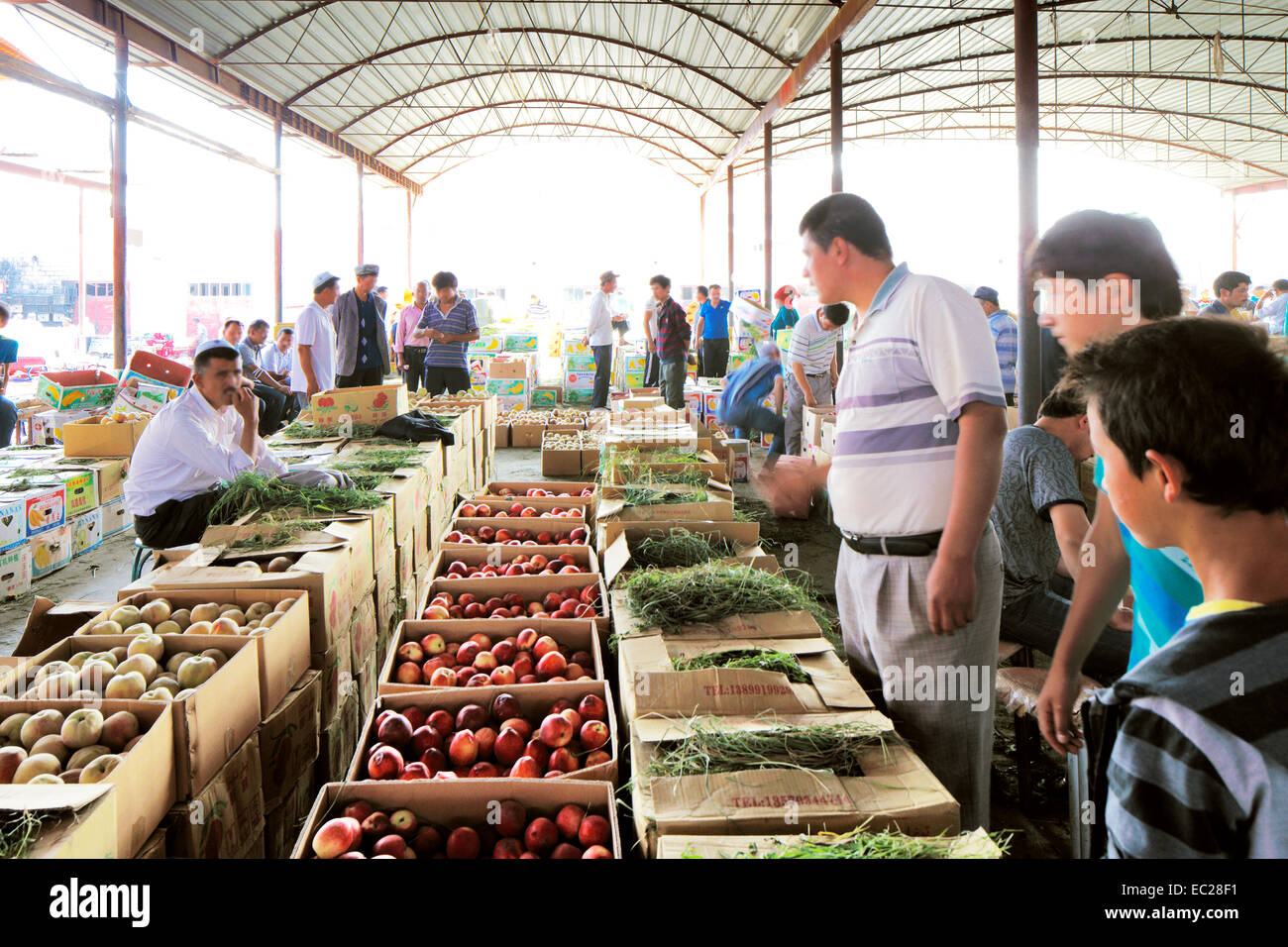 Men sell fruit and fresh farm produce at Zhongxiya Shichang, a popular ...