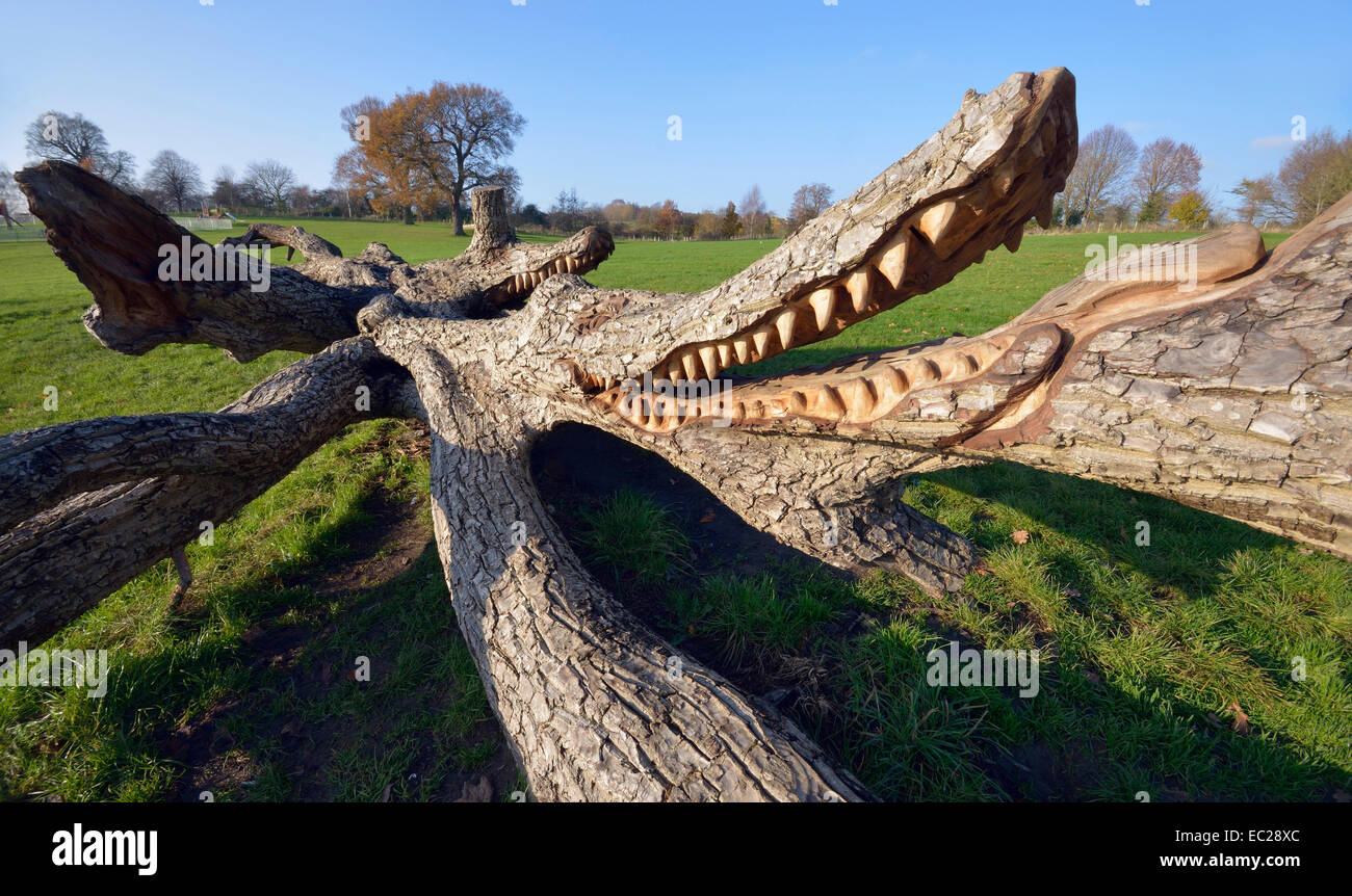 Crocodile sculpture in fallen tree Stratford Park, Stroud Stock Photo ...