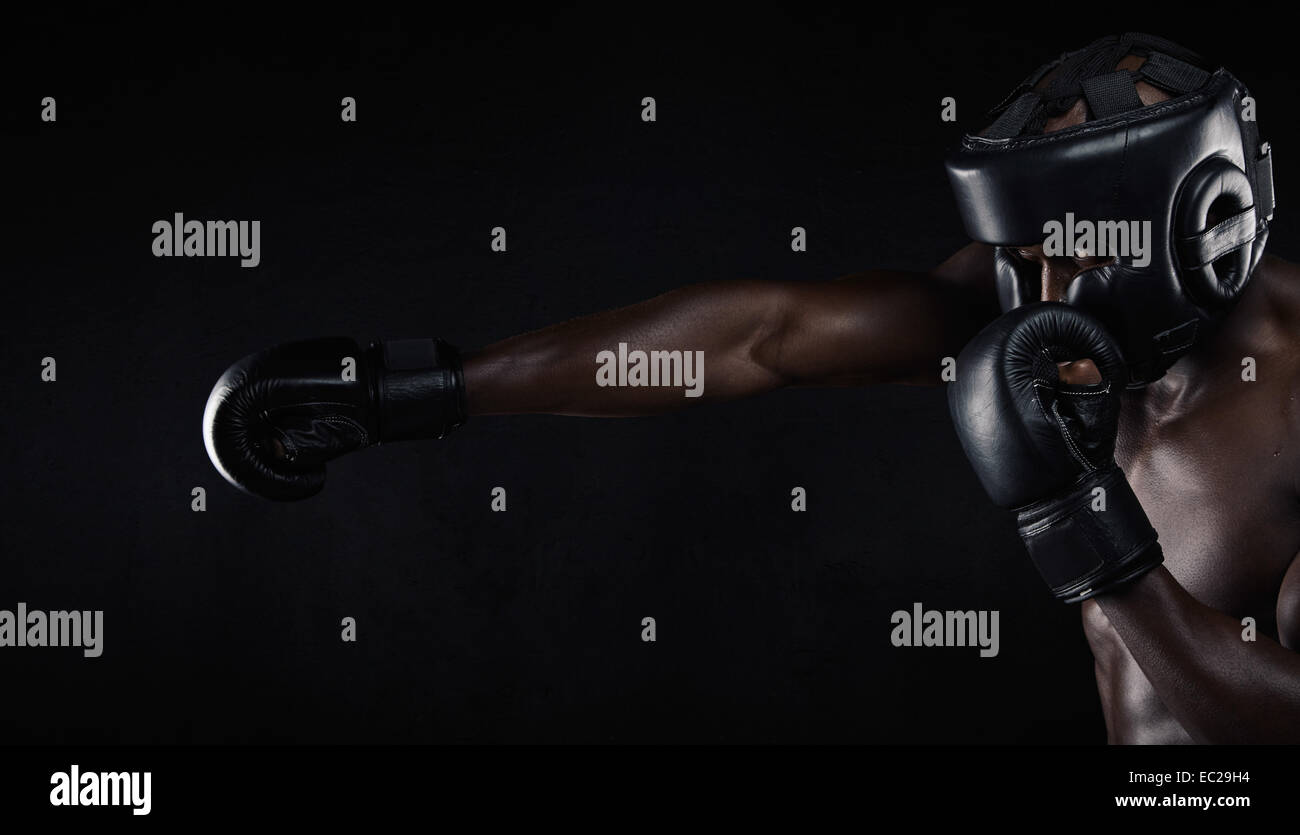 Image of African male boxer boxing against black background. Young man ...