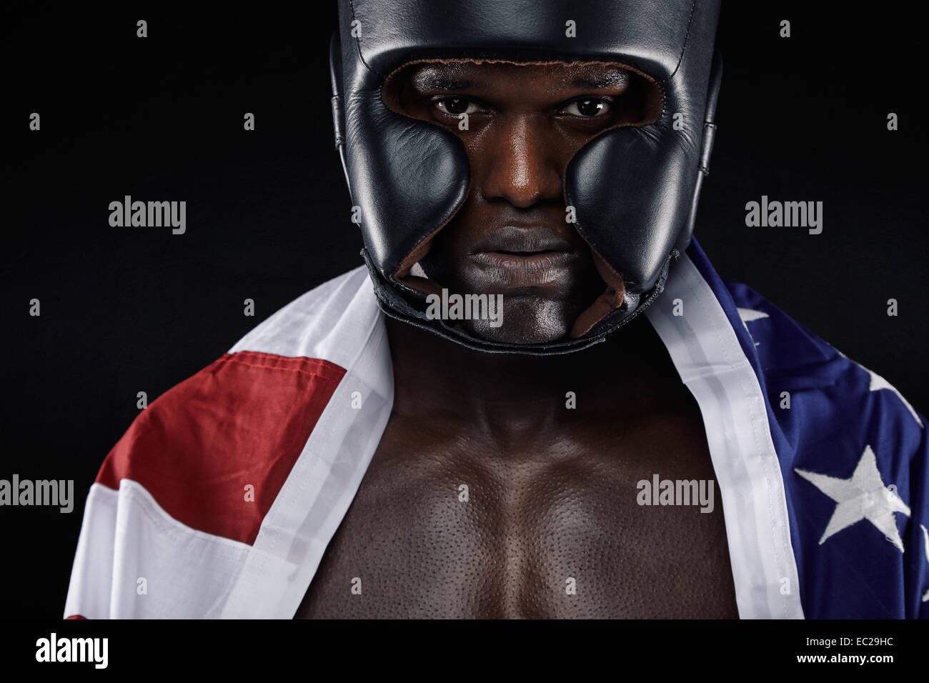 Close-up portrait of young male wearing boxing helmet with American ...
