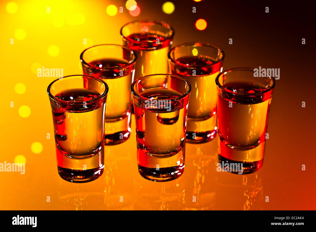 Glasses with an alcoholic drink on a glass table Stock Photo - Alamy