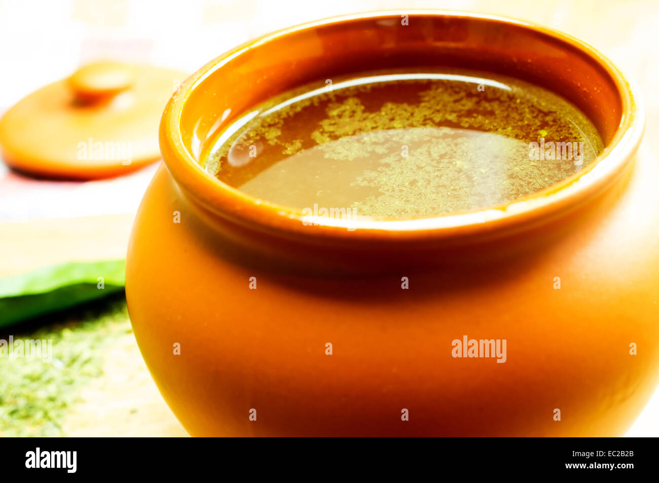 Broth, bouillon, clear soup in a clay pot, close-up Stock Photo - Alamy