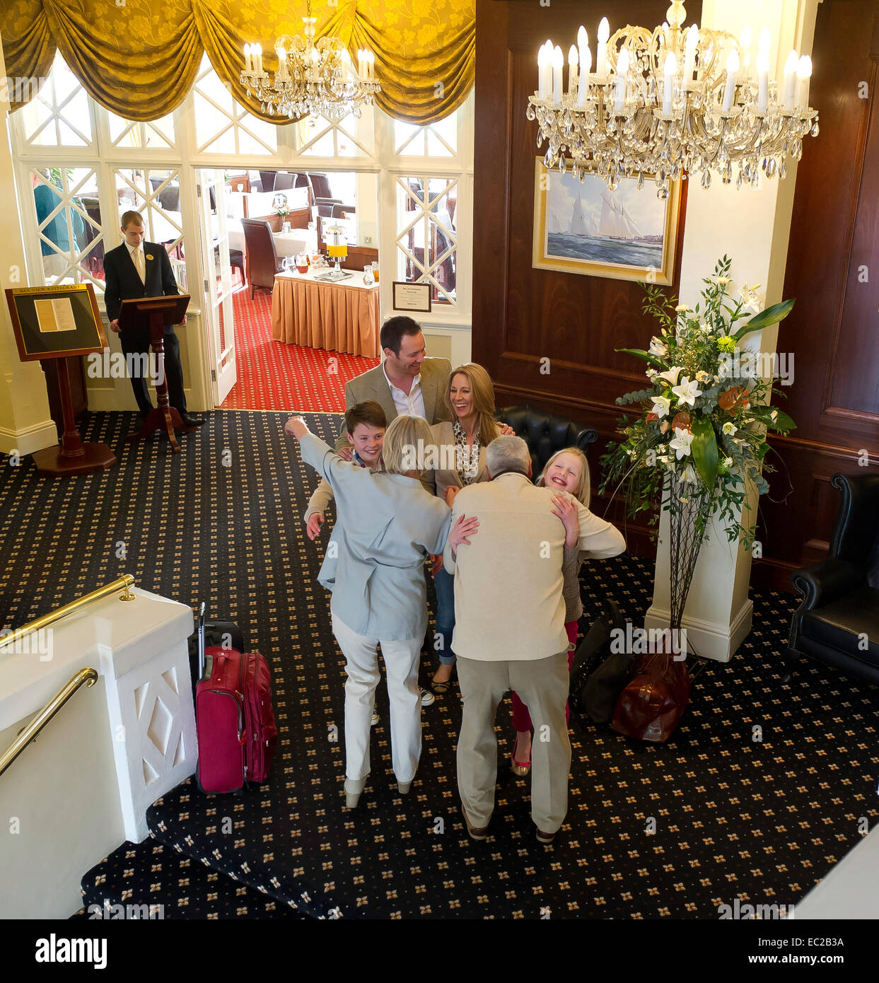 An extended family meeting up in a hotel lobby England UK Stock Photo ...