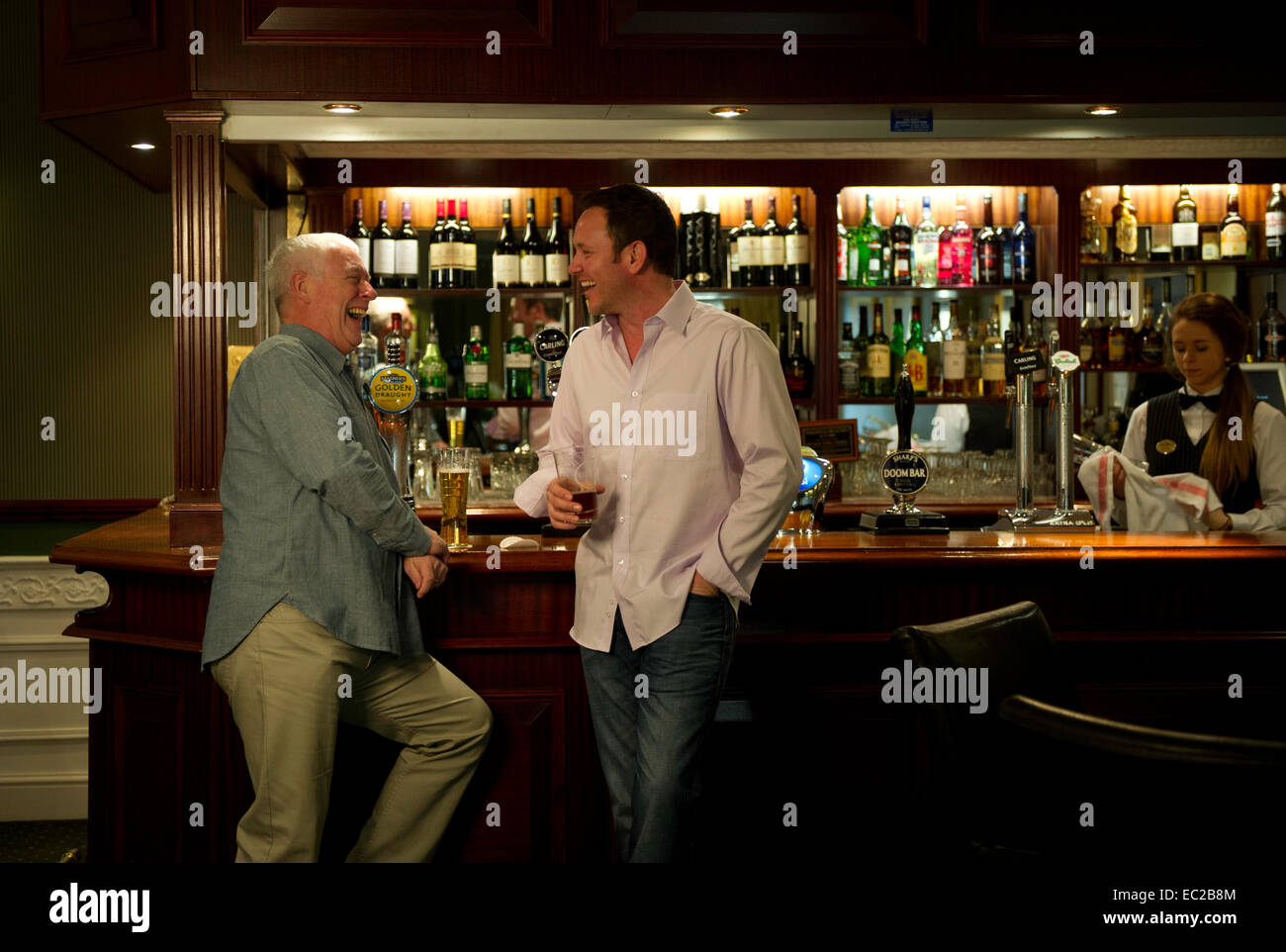 Two men chatting at a hotel bar Stock Photo - Alamy