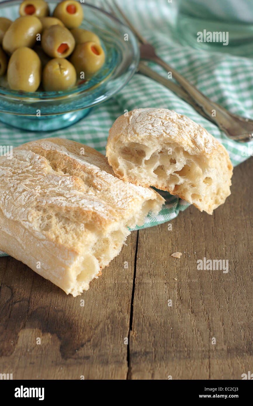 Ciabatta Italian bread and olives in a rustic setting Stock Photo - Alamy