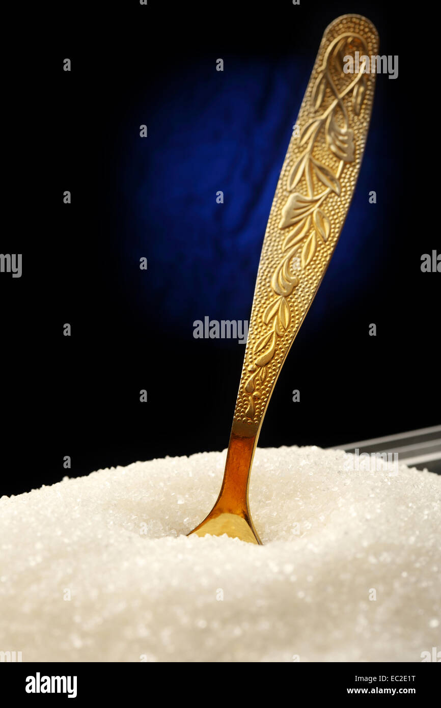 Heap of white sugar and spoon Stock Photo - Alamy