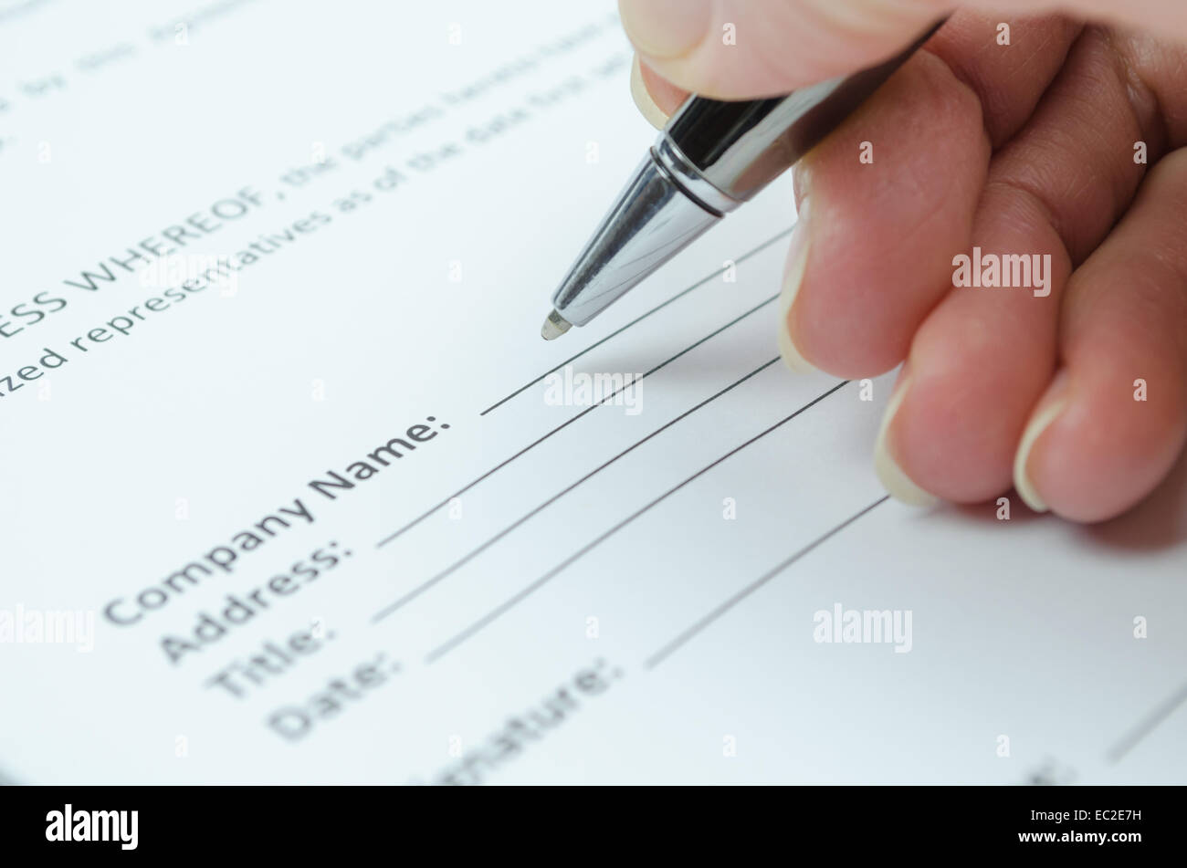 Female hand filling document Stock Photo - Alamy