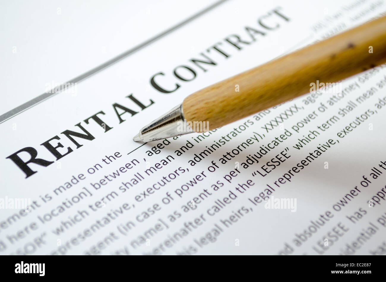 Filling a rental contract with wooden pen Stock Photo - Alamy