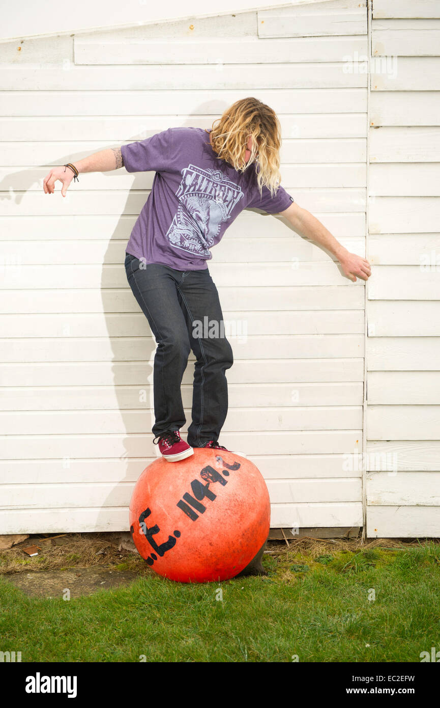 A man balances on a ball Stock Photo - Alamy