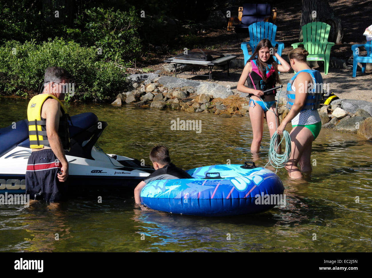 Young girls in bikinis and life vests getting ready to water ski Stock ...