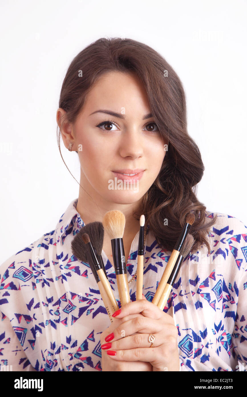Girl makeup artist with brushes in hand Stock Photo - Alamy