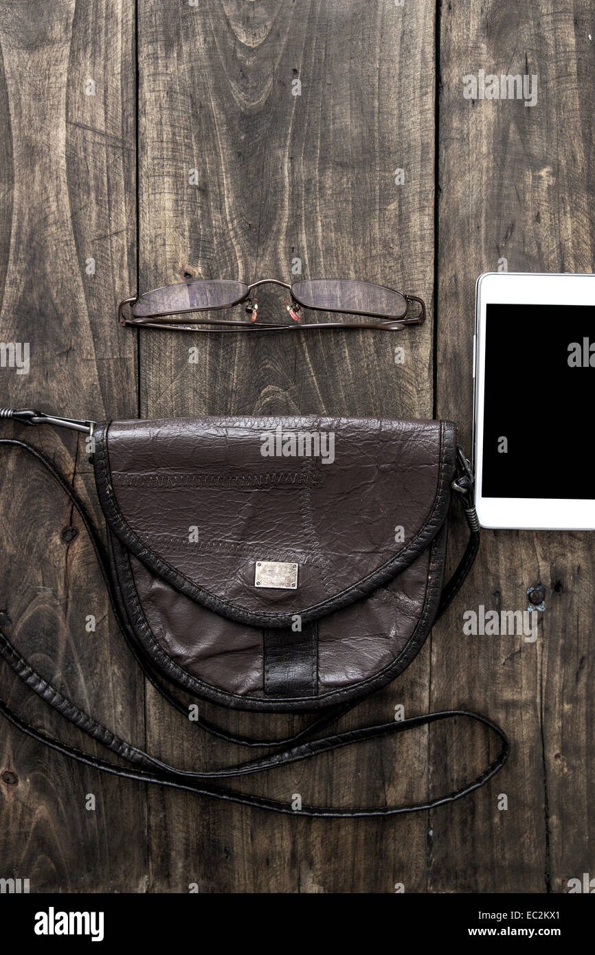 woman bag stuff, handbag over rustic wooden background Stock Photo - Alamy