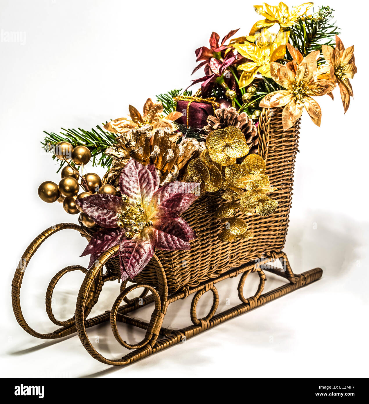 wicker sled as xmas sleigh filled with decorations Stock Photo - Alamy