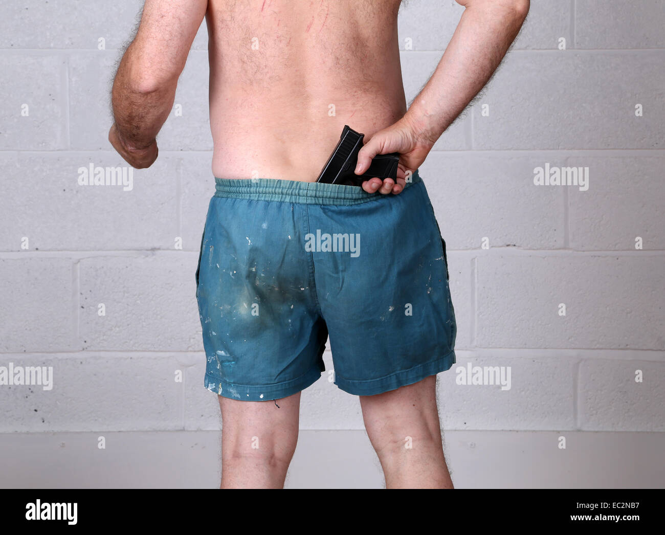 Rear view man holding gun hi-res stock photography and images - Alamy