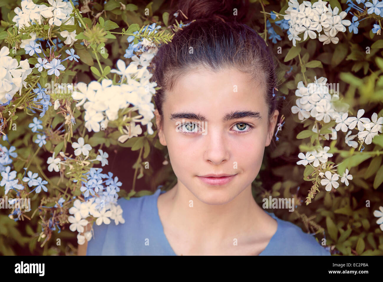portrait of a beautiful teenage girl in a blooming bush Stock Photo - Alamy