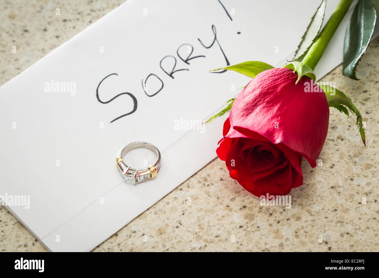 concept of a lost relationship with a letter, a red rose and an ...