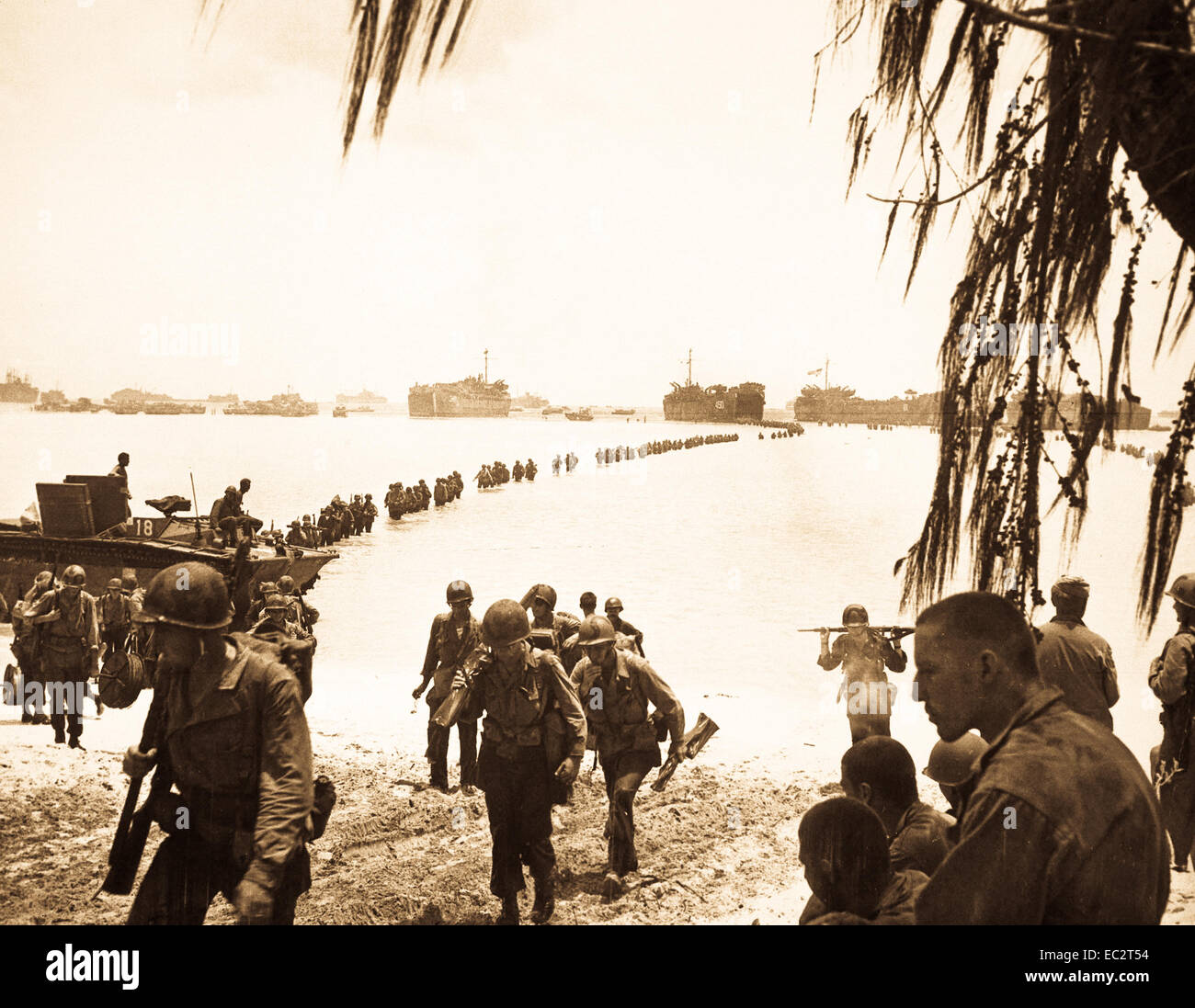 Army reinforcements disembarking from LST's form a graceful curve as ...