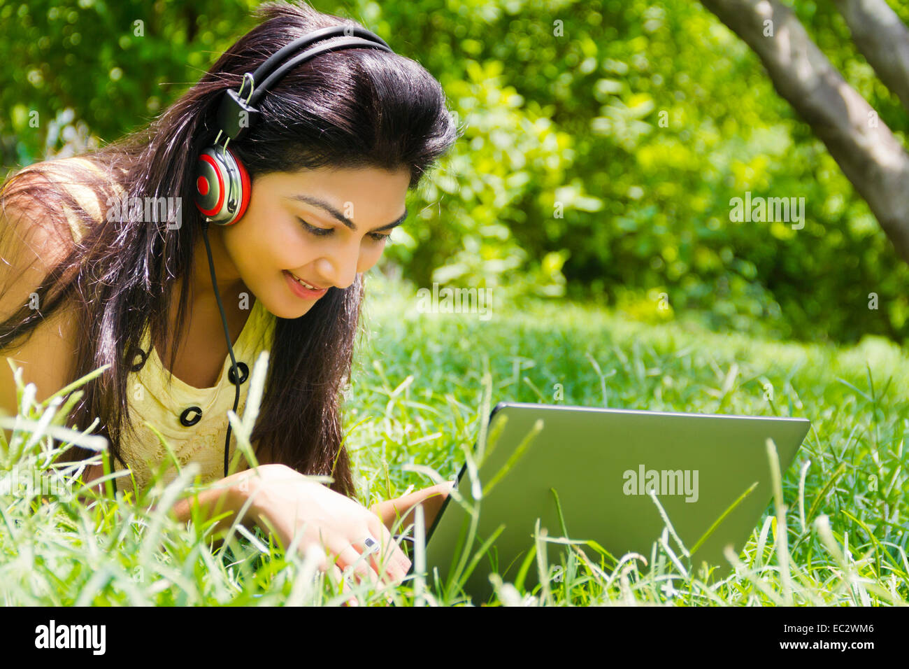 indian Beautiful lady park Hearing Music Stock Photo - Alamy