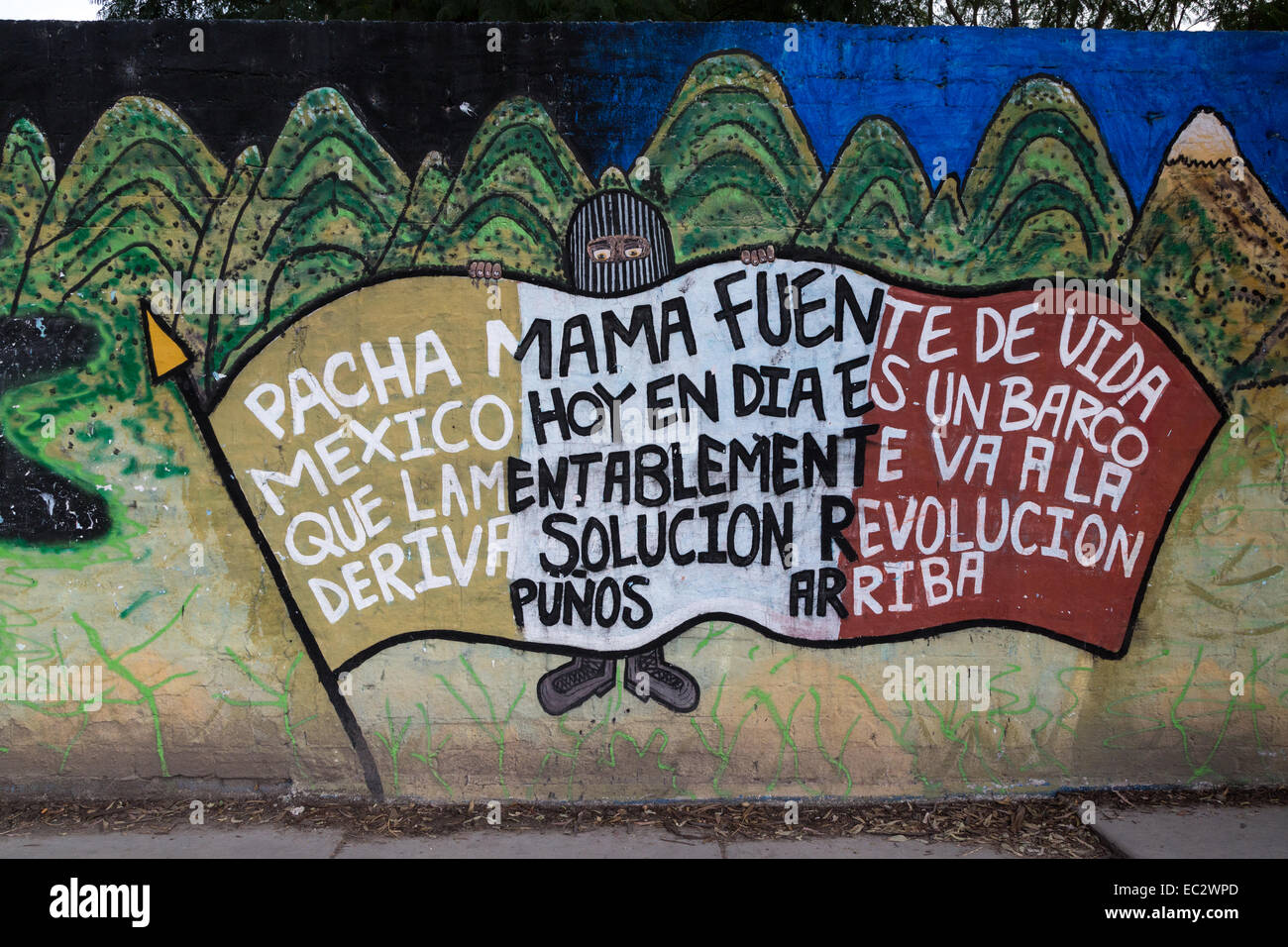 Urban art showing a masked Mexican man holding a revolution banner in ...