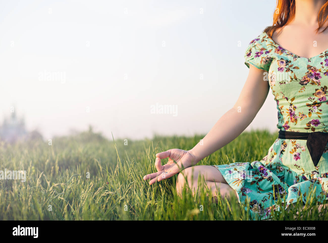 Pretty woman meditate in the park Stock Photo - Alamy