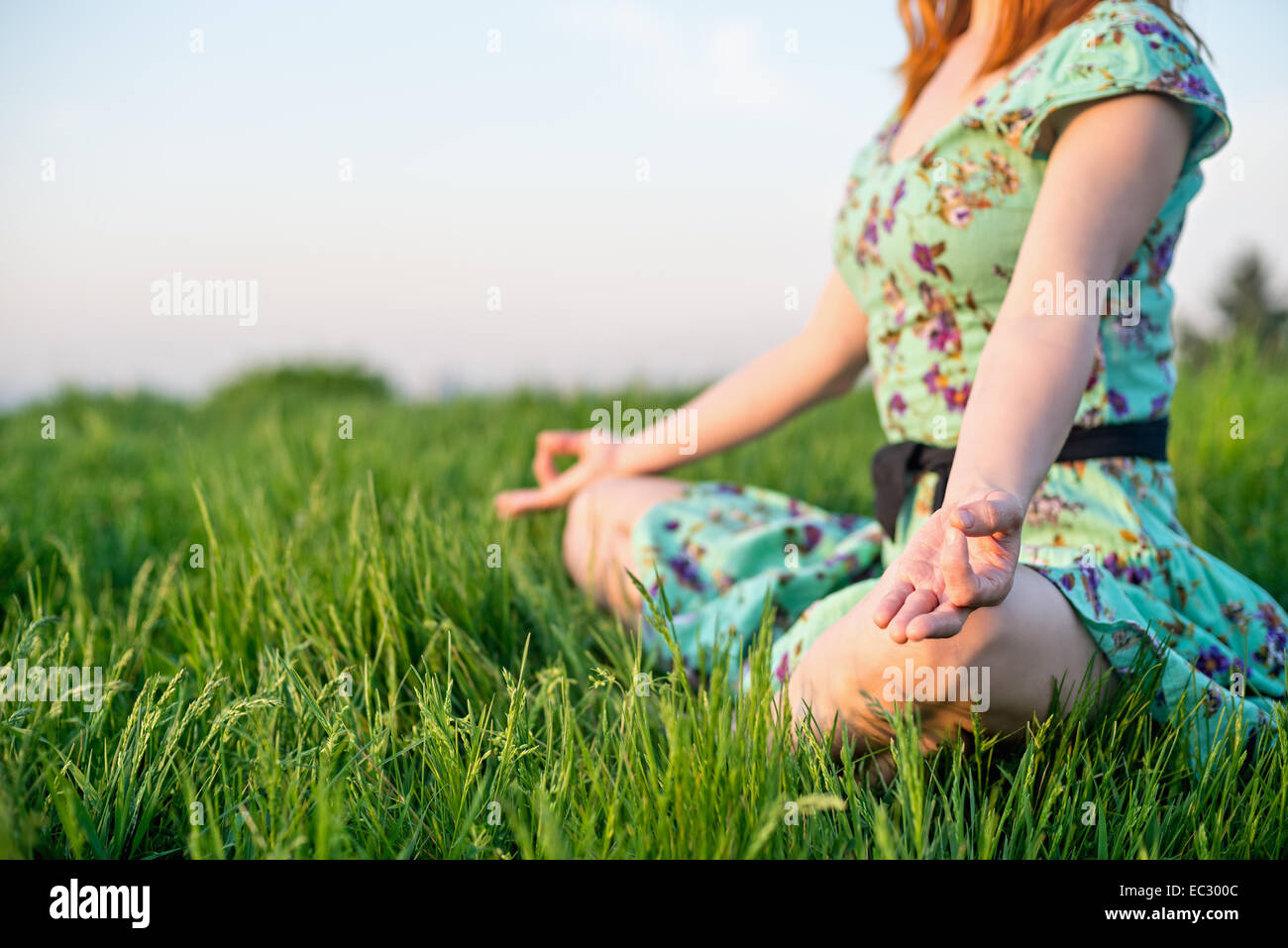 Pretty woman meditate in the park Stock Photo - Alamy