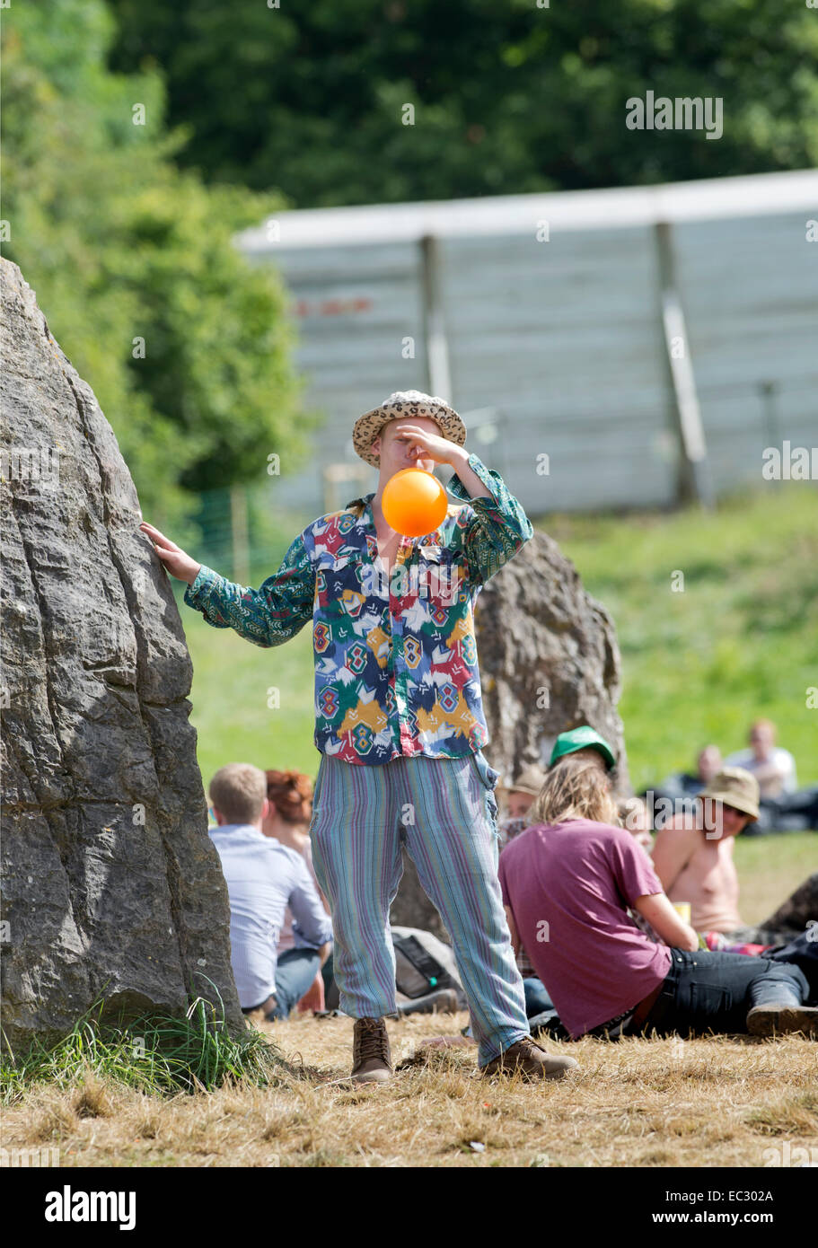 A man appears to inhale gas from a balloon at the Glastonbury Festival ...