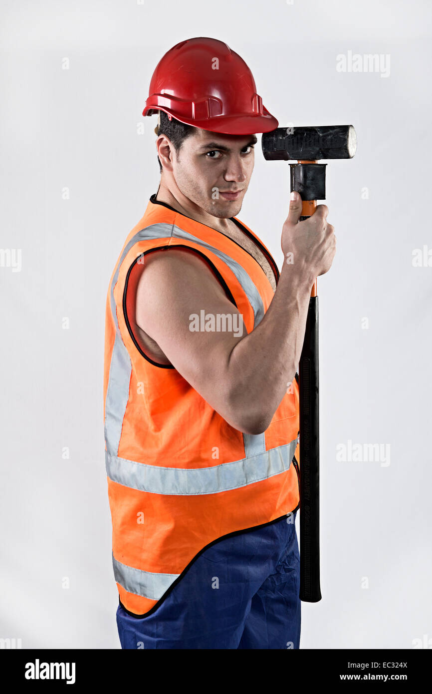 Young fit male shirtless workman with sledge hammer wearing a ...
