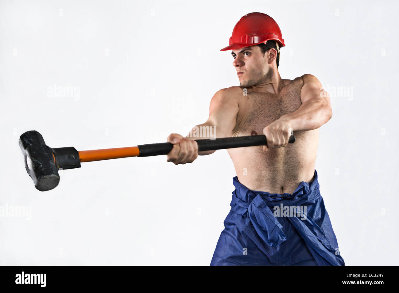 Young fit male shirtless workman with sledge hammer and safety hat ...