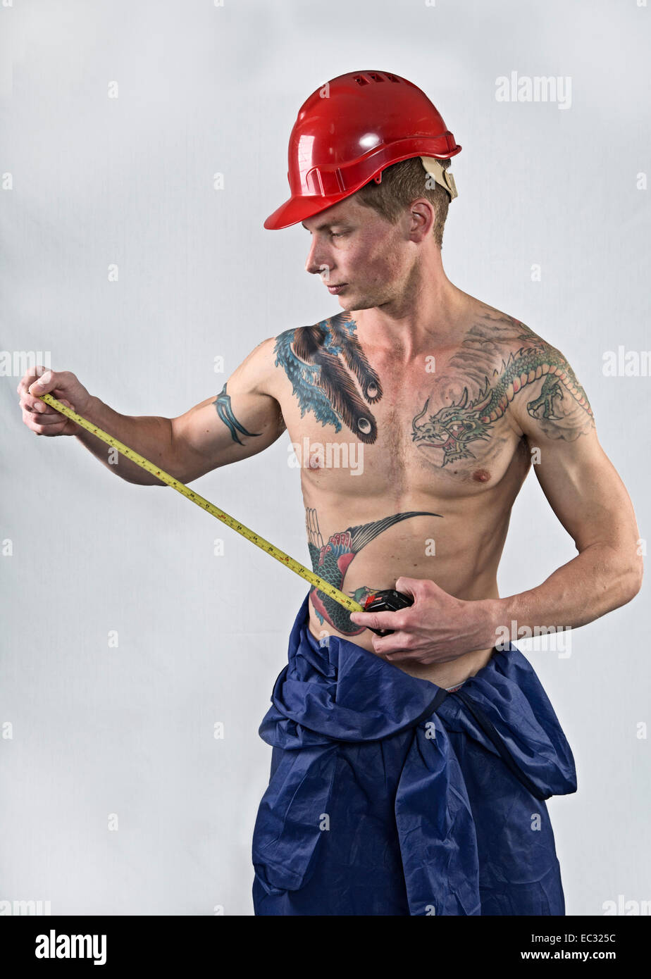 Young fit male shirtless workman with tape measure and safety hat Stock ...
