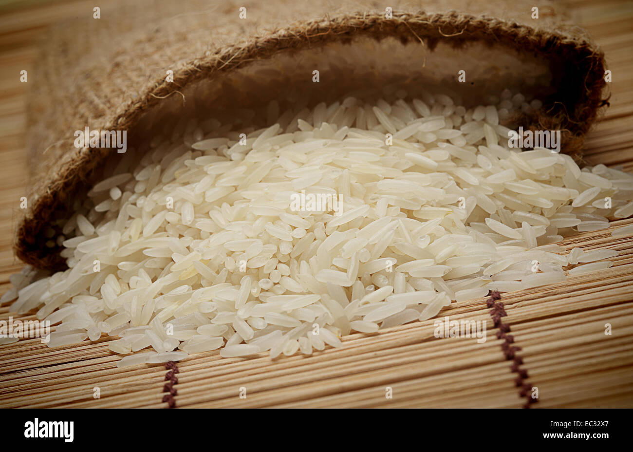 White uncooked rice in small sack Stock Photo - Alamy