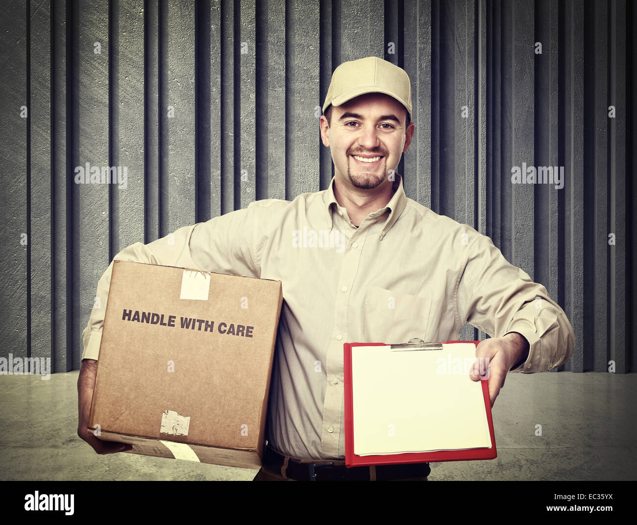 delivery man portrait and concrete background Stock Photo - Alamy