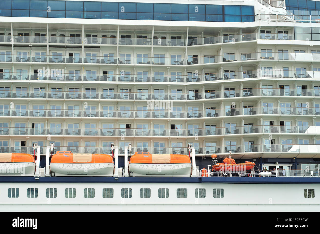 Side detail of large multi-story cruise ship with rows of cabin ...