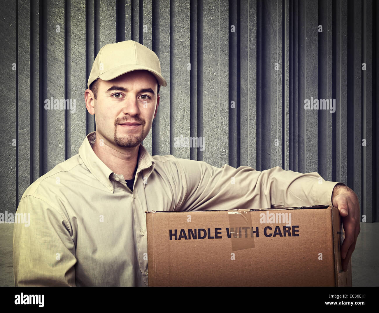 delivery man portrait and concrete background Stock Photo - Alamy